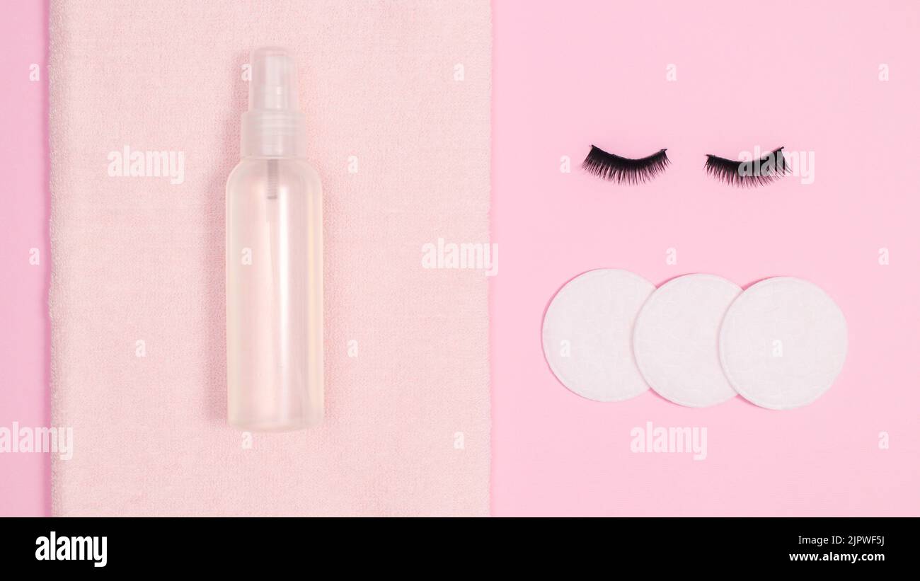 Beauty and cosmetics products with eye lashes on pastel pink background ...
