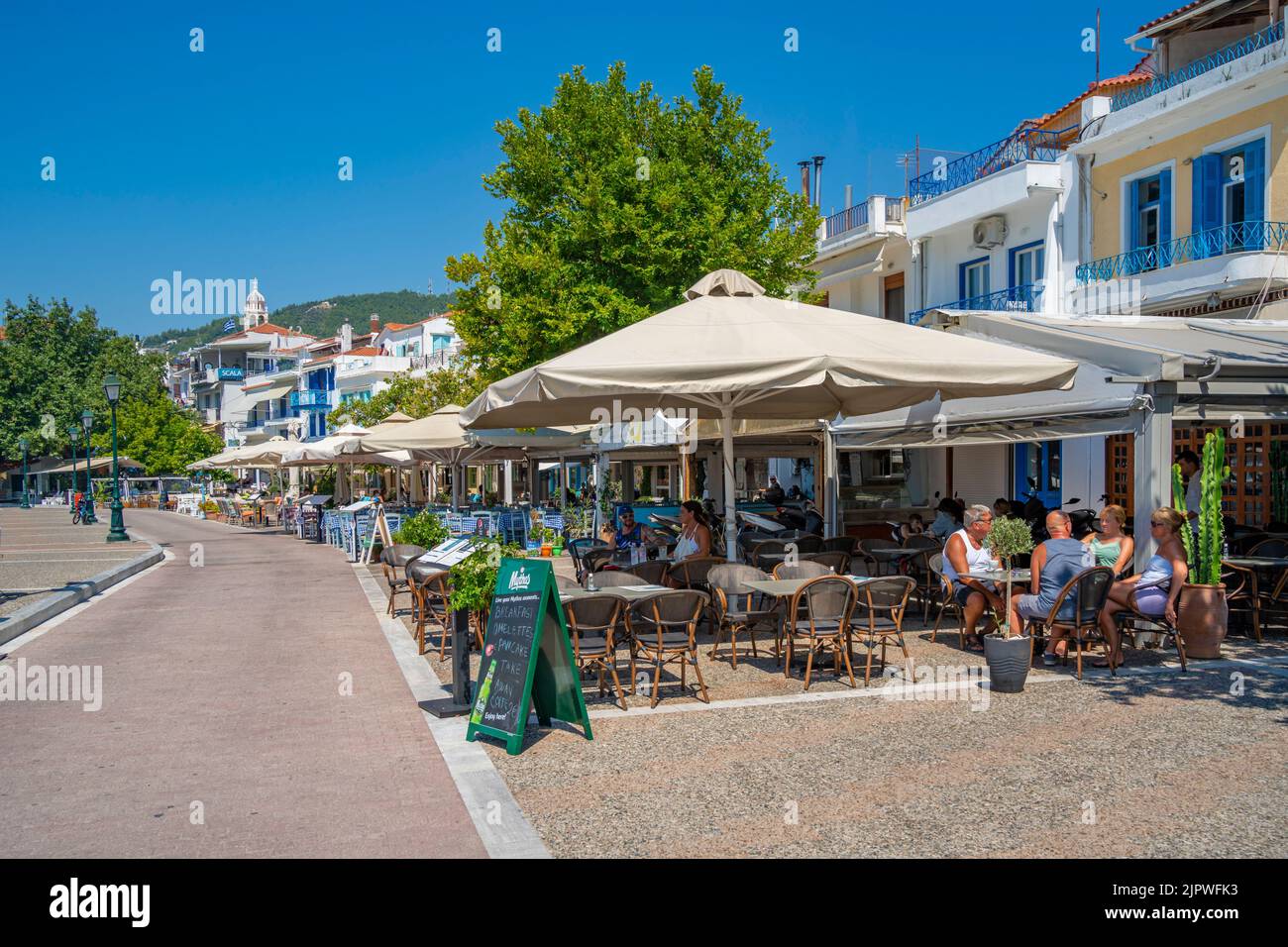 View of sea front restaurants overlooked by Greek Orthodox Church ...