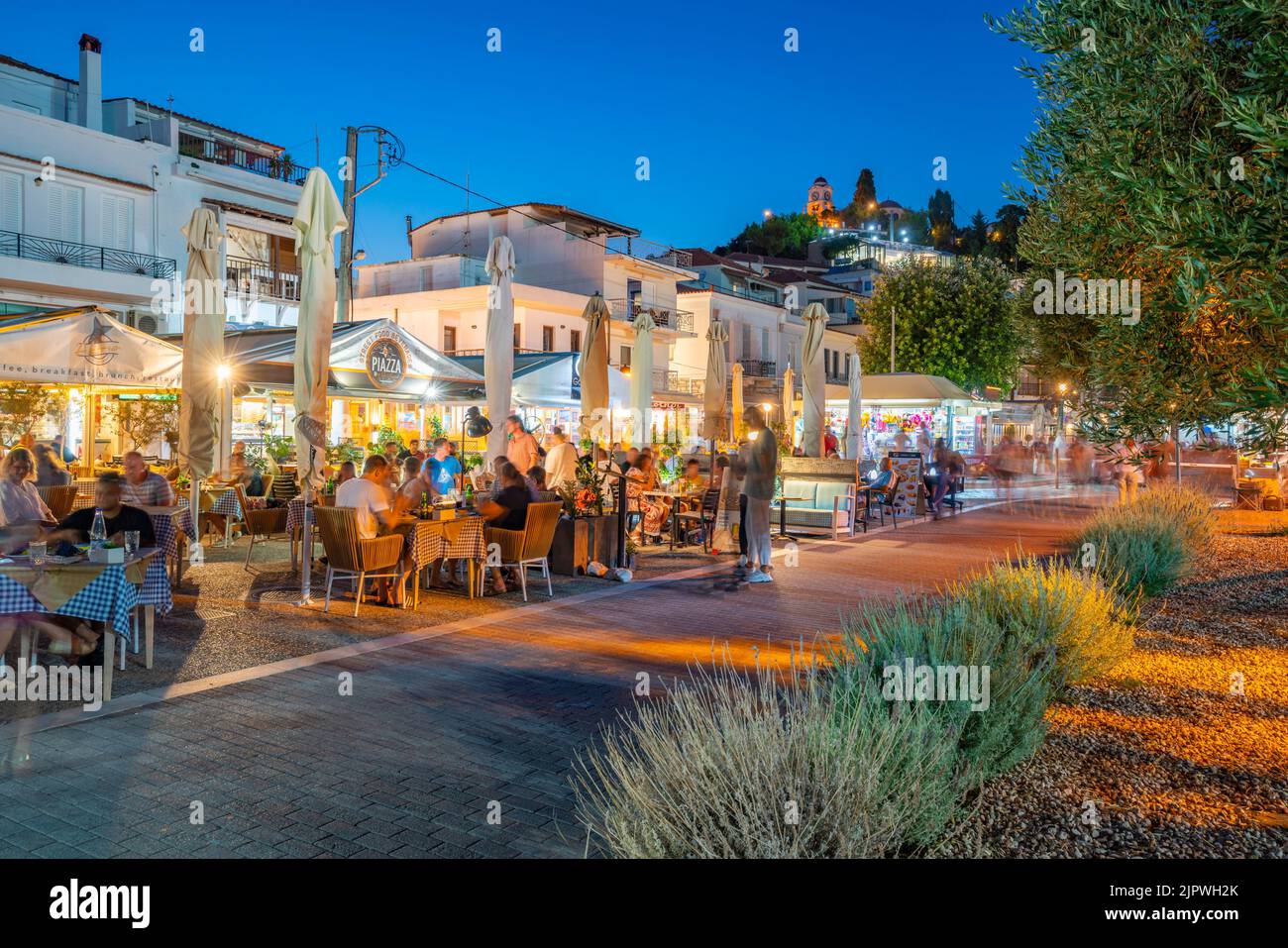 View of sea front restaurants overlooked by Greek Orthodox Church at ...