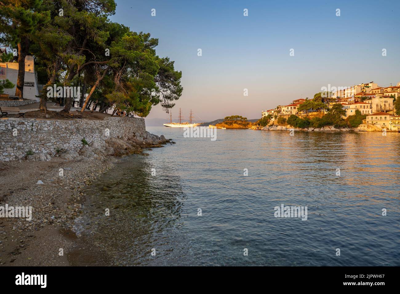 View of sailing ship and Belvedere Skiathos Old Port at sunrise in ...