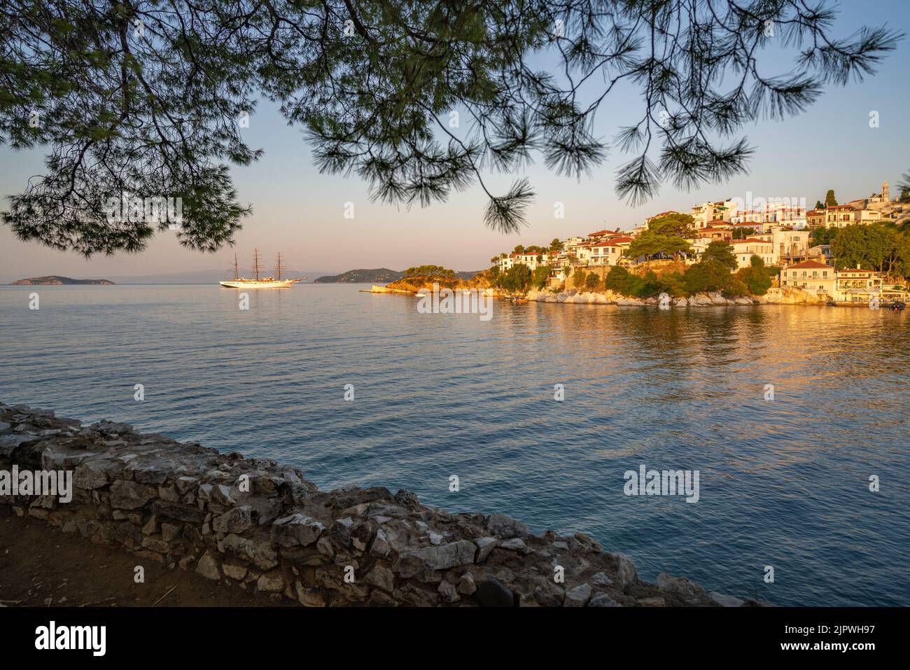 View of sailing ship and Belvedere Skiathos Old Port at sunrise in ...