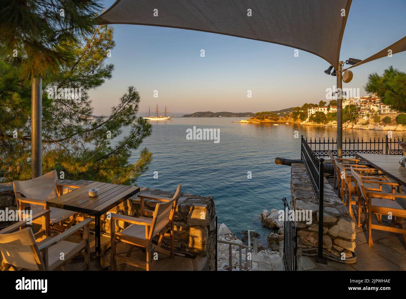 View of sailing ship and Belvedere Skiathos Old Port at sunrise in ...