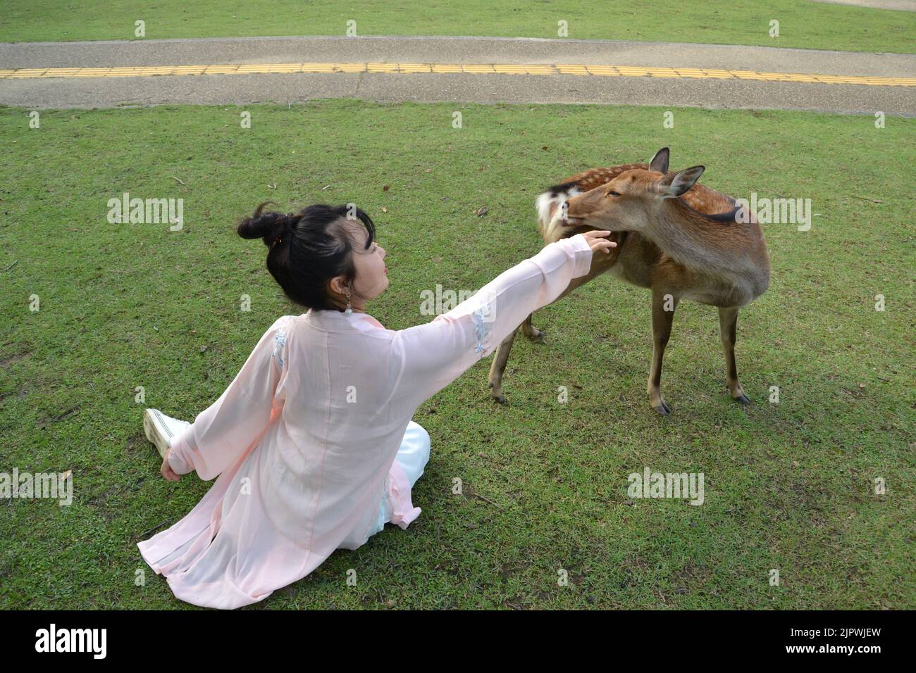 An East Asian young woman in Han Chinese traditional clothing sitting ...