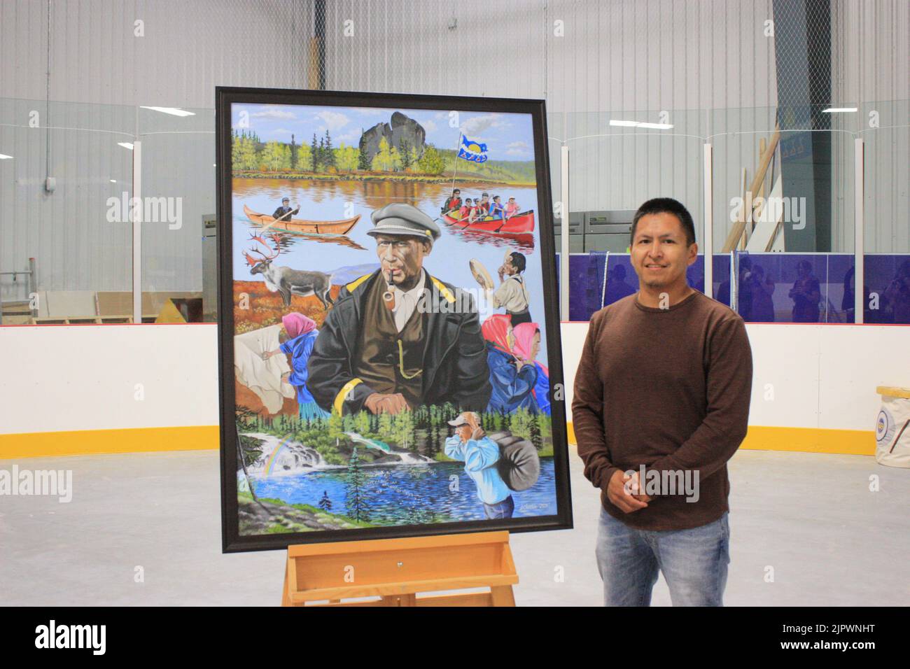 Tlicho artist Darrell Chocolate stands beside a painting commissioned ...