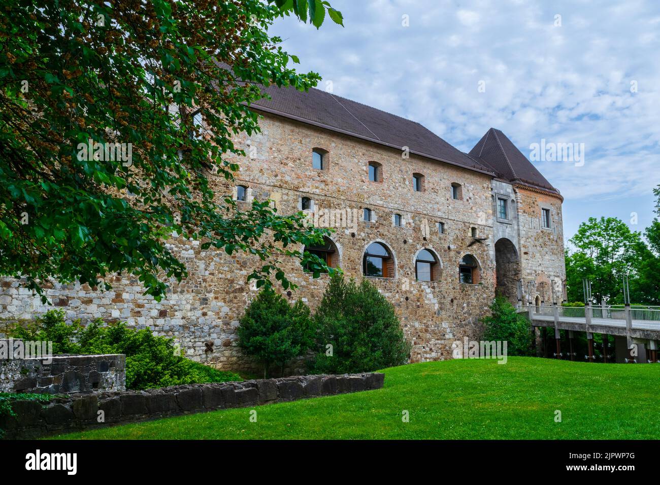 Visitors walk along the moat area to arrive at the main entrance of the ...