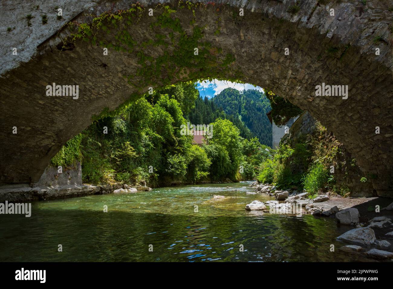 Ancient arch bridge over mountain river Stock Photo - Alamy