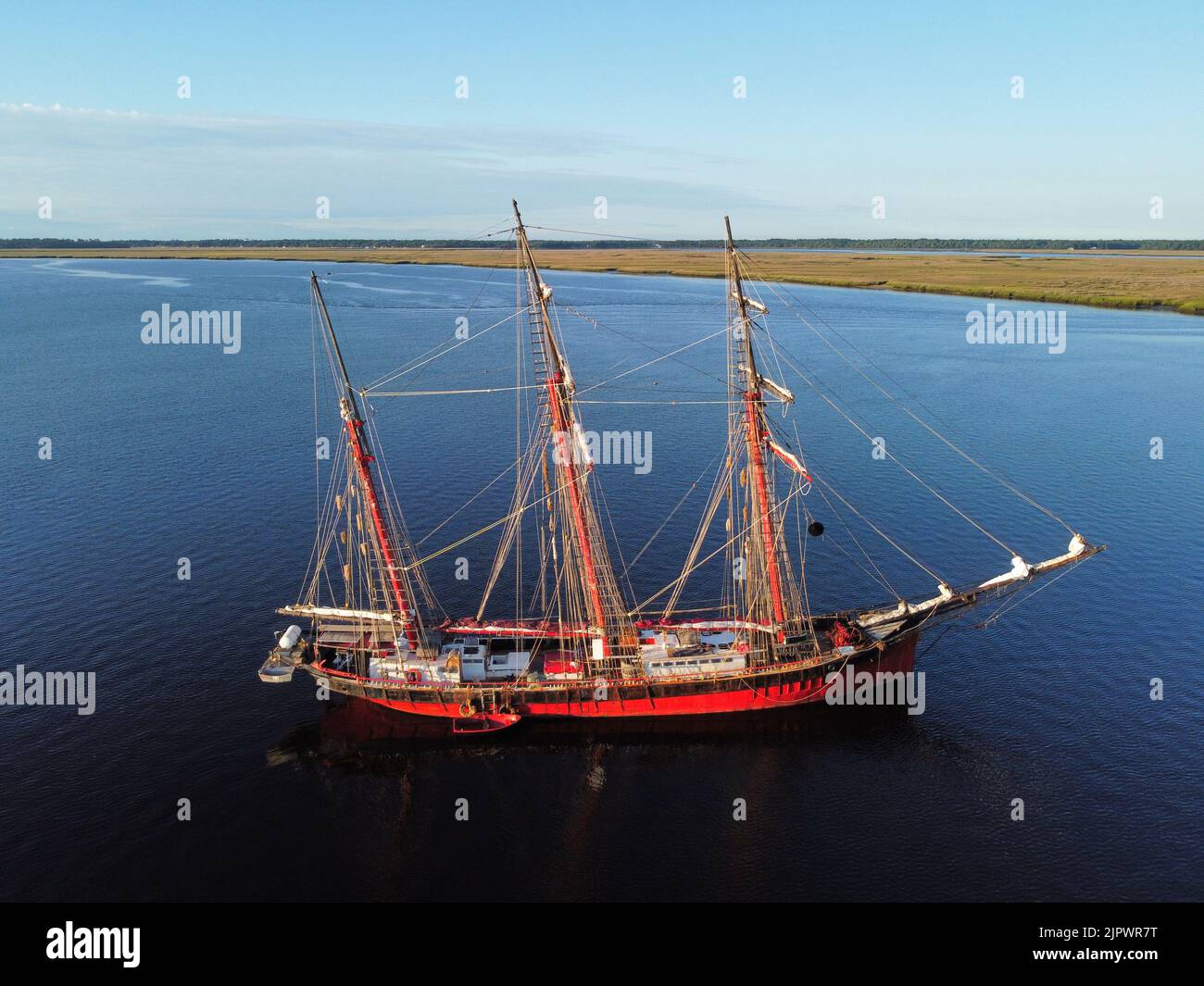 A red wooden vintage ship sailing in the sea under blue sky Stock Photo ...