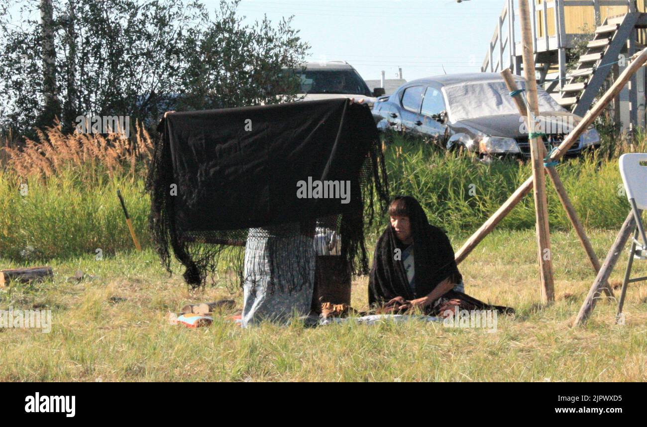 Women, wearing traditional clothing of the time, participate in the re ...