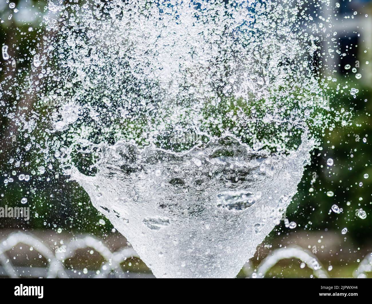 Water splashes from fountain on dark background. Natural texture of ...
