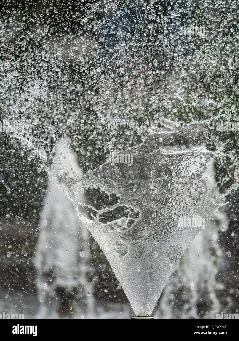 Water splashes from fountain on dark background. Natural texture of ...