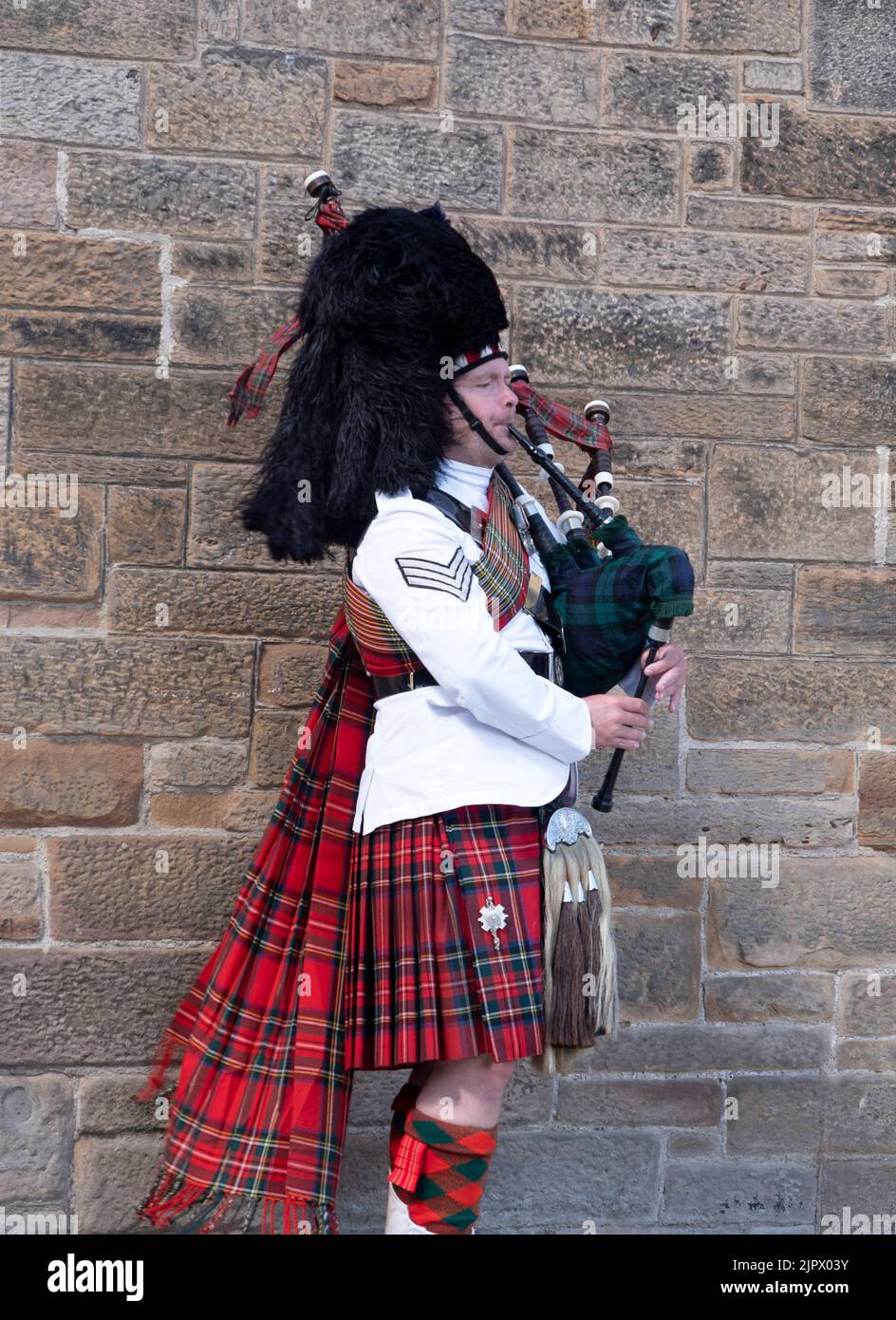 Man in traditional Scottish outfit with bagpipe on the street Stock ...