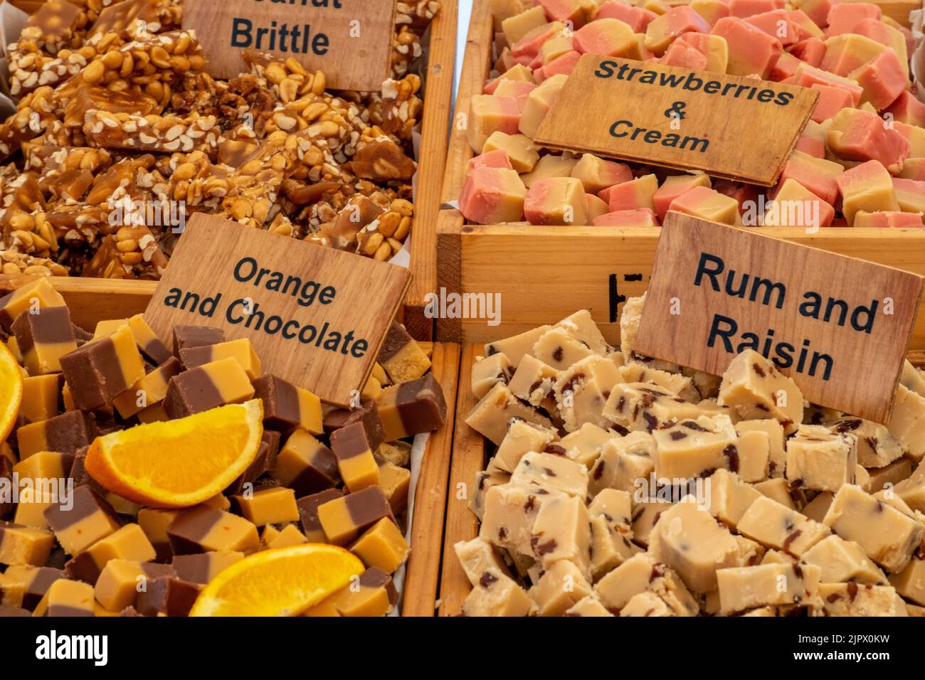variety of flavoured fudge in trays on show at market stall selling ...
