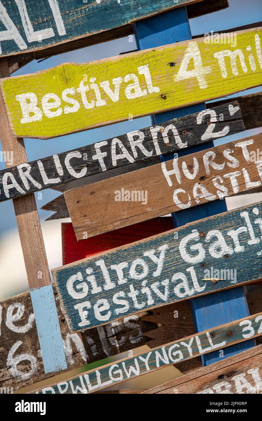 wooden painted signs and direction mileage indicators at the isle of ...