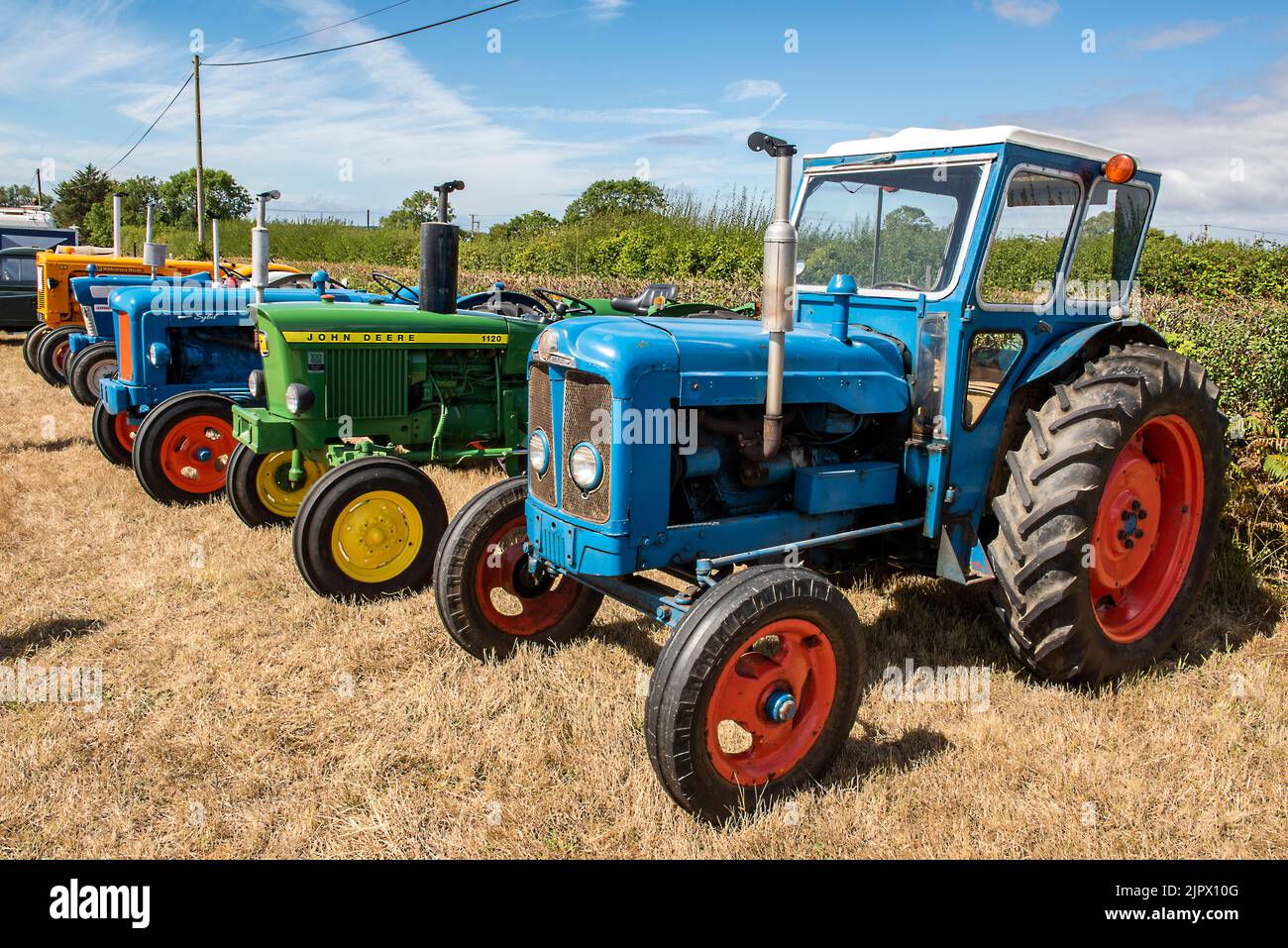row of vintage tractors at the garlic festival on the isle of wight, vintage farm machinery on ...