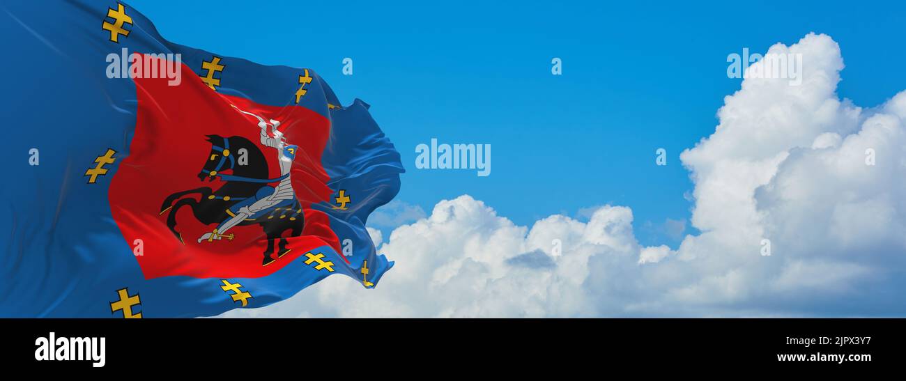 official flag of Vilnius County lithuania at cloudy sky background on ...