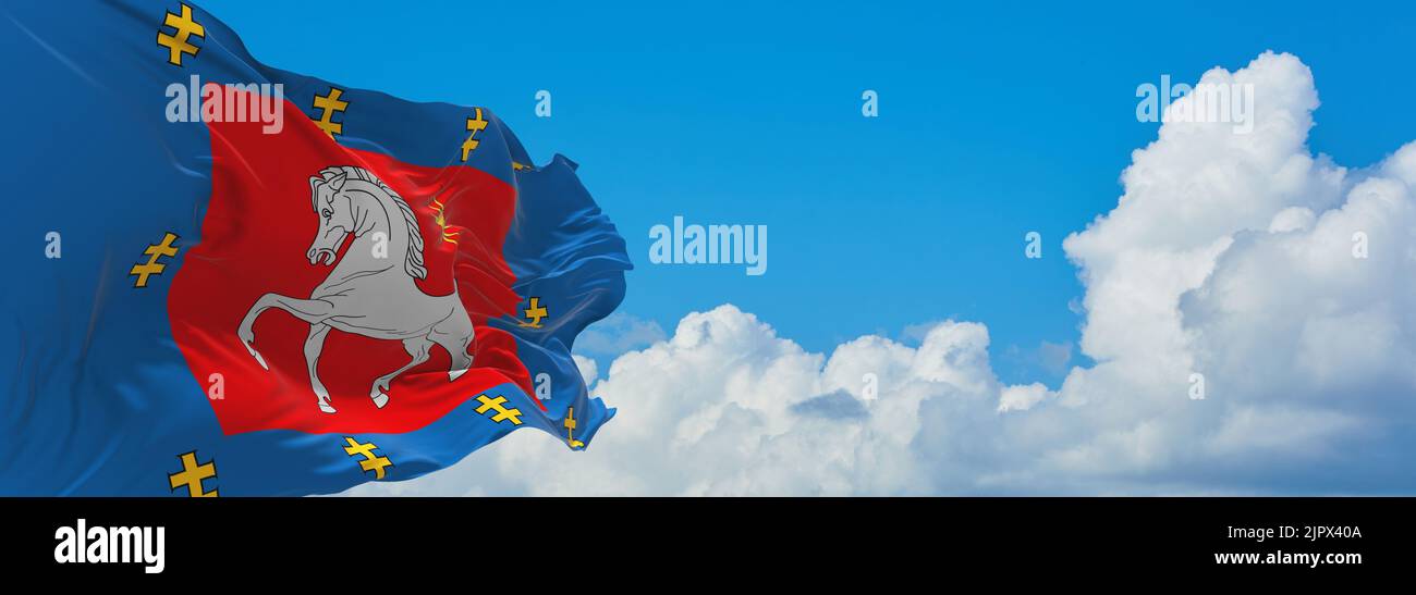 official flag of Utena County lithuania at cloudy sky background on ...