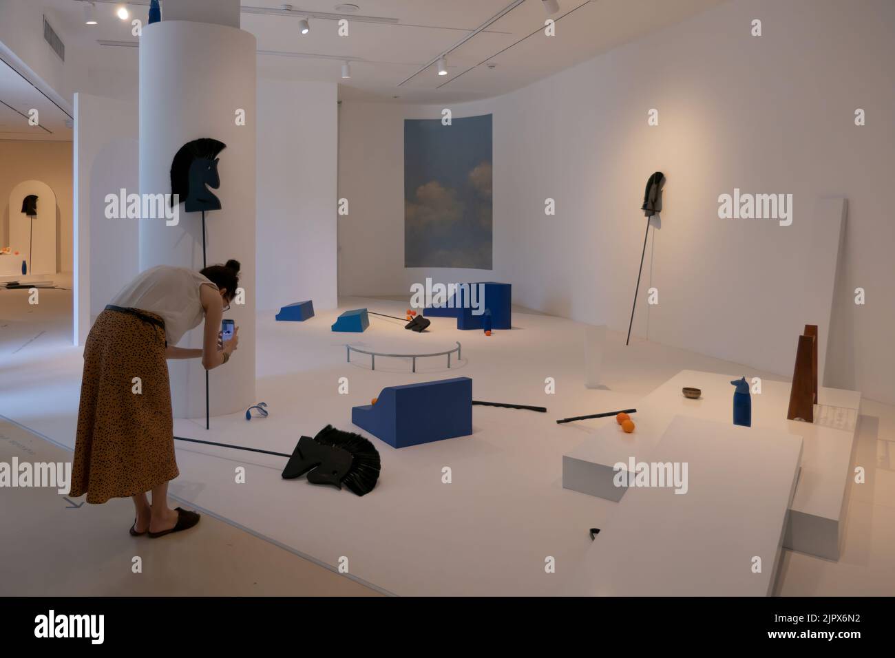 A visitor using her cellular phone to photograph art installation by ...