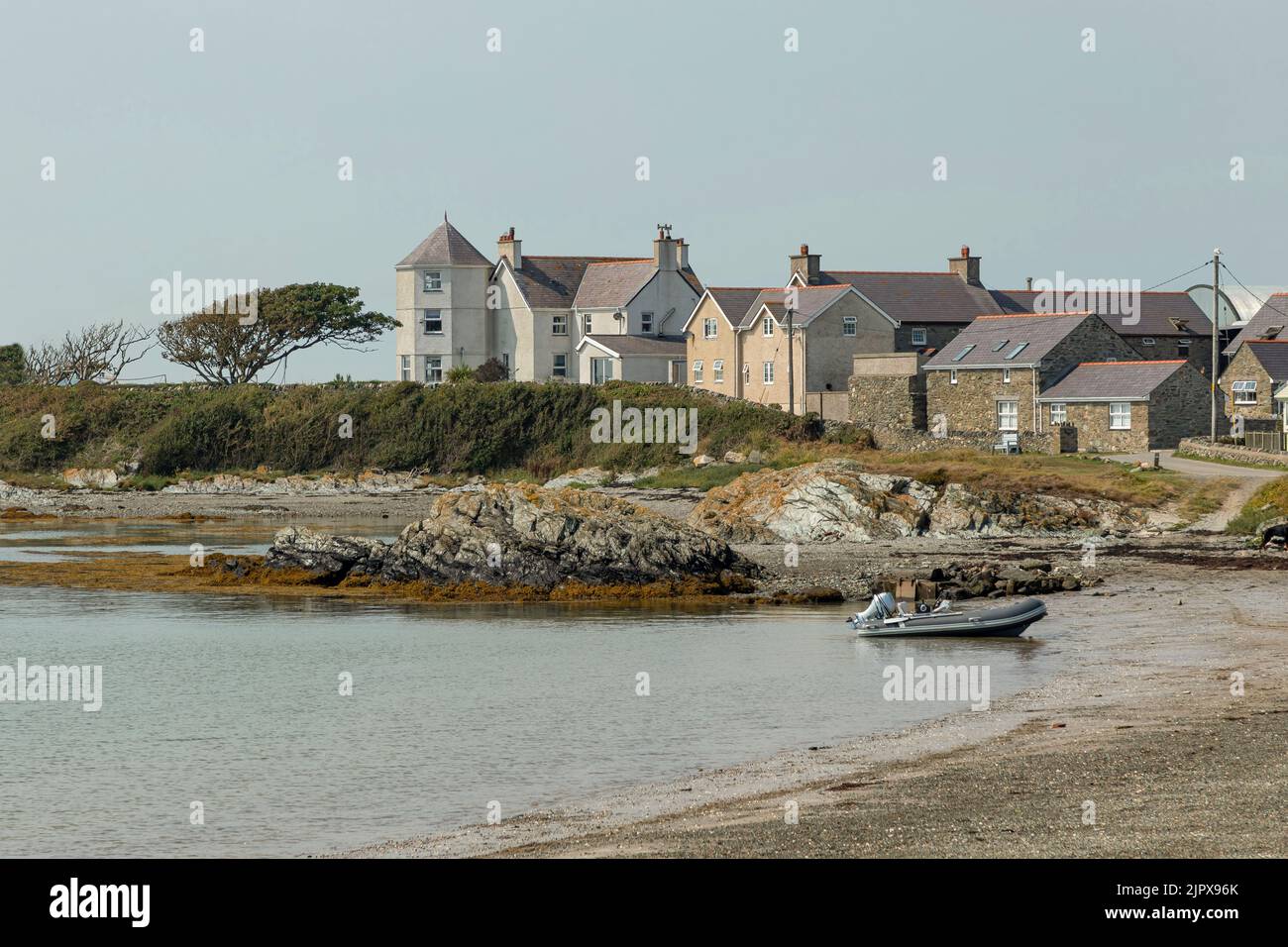Looking across the shore at an estate of stone buildings a farm and a ...