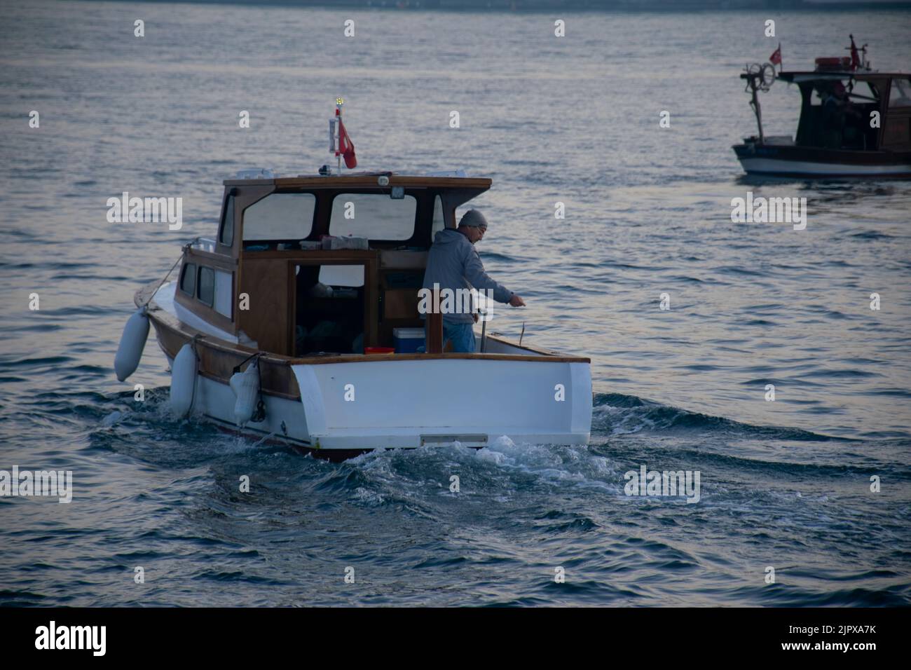 Men on a boat in Bosphorus waters in Istanbul. Fisherman in boat in ...