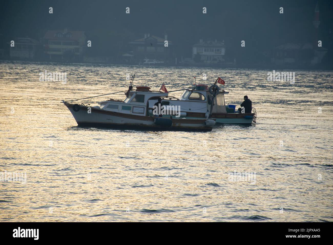 Men on a boat in Bosphorus waters in Istanbul. Fisherman in boat in ...