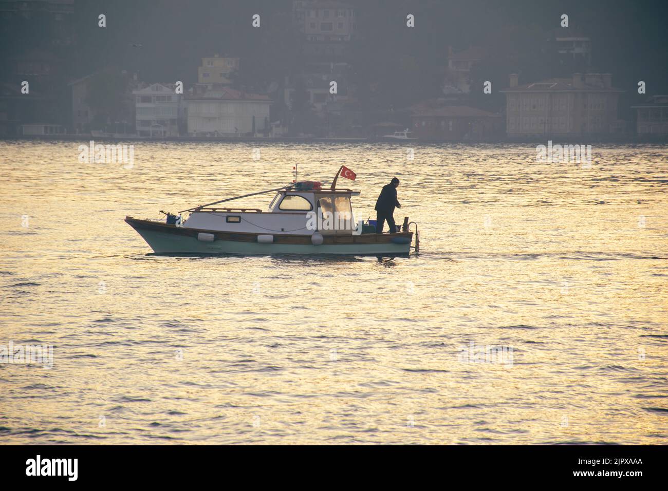 Men on a boat in Bosphorus waters in Istanbul. Fisherman in boat in ...
