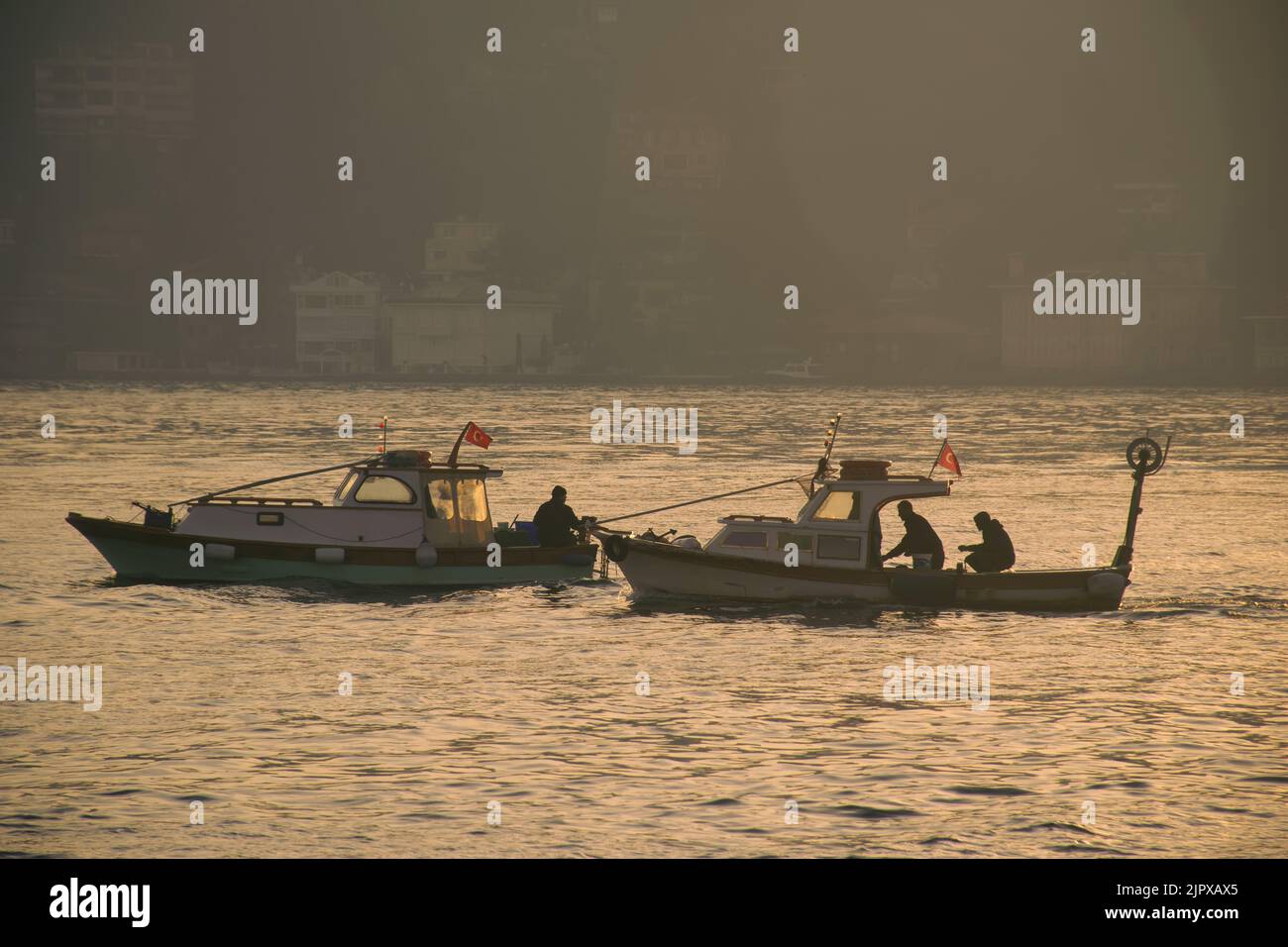 Men on a boat in Bosphorus waters in Istanbul. Fisherman in boat in ...