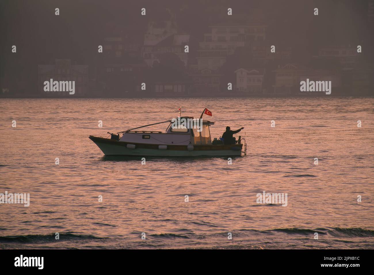 Men on a boat in Bosphorus waters in Istanbul. Fisherman in boat in ...