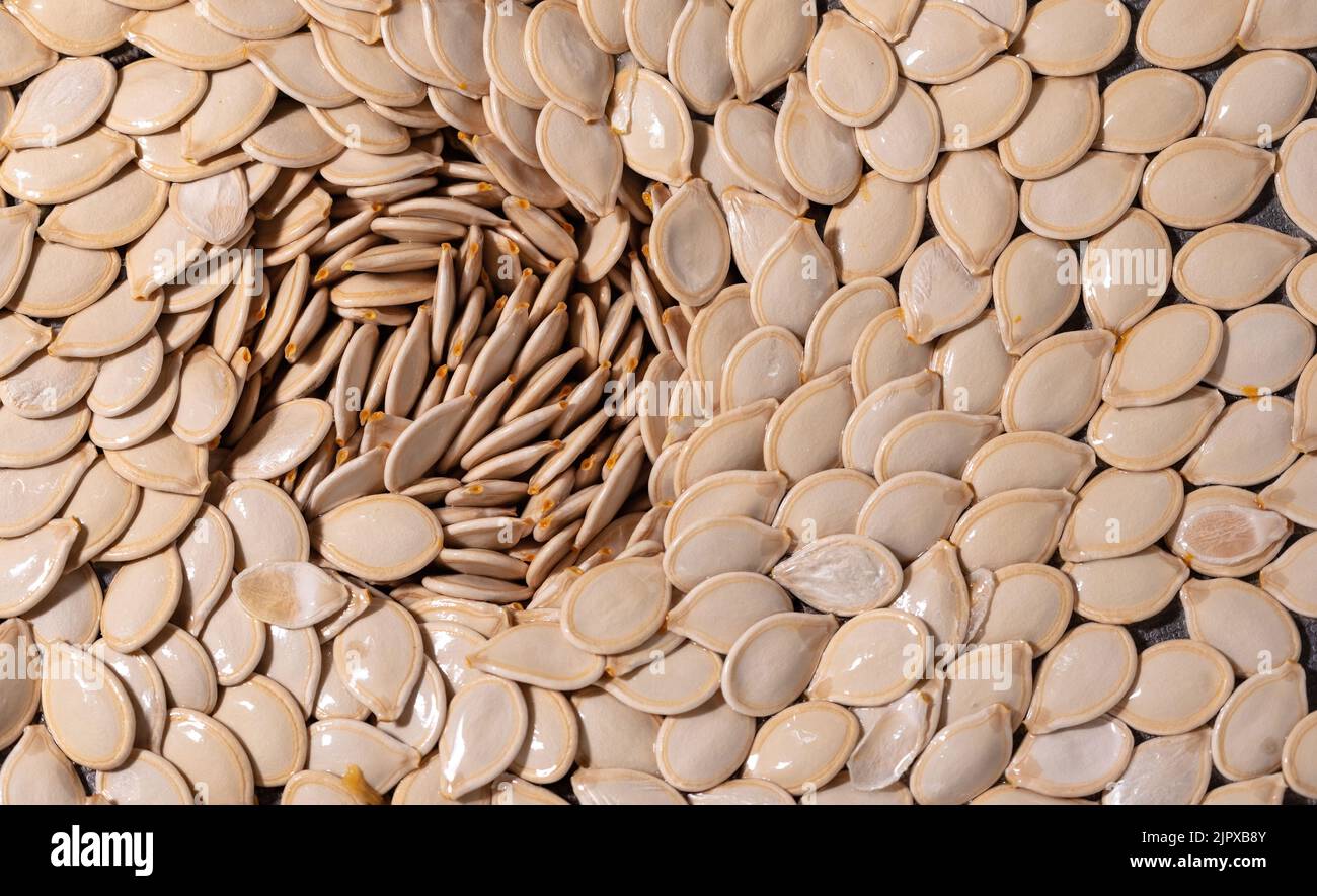 Pumpkin seeds creating a natural, spiral structure. Pure pumpkin seeds ...