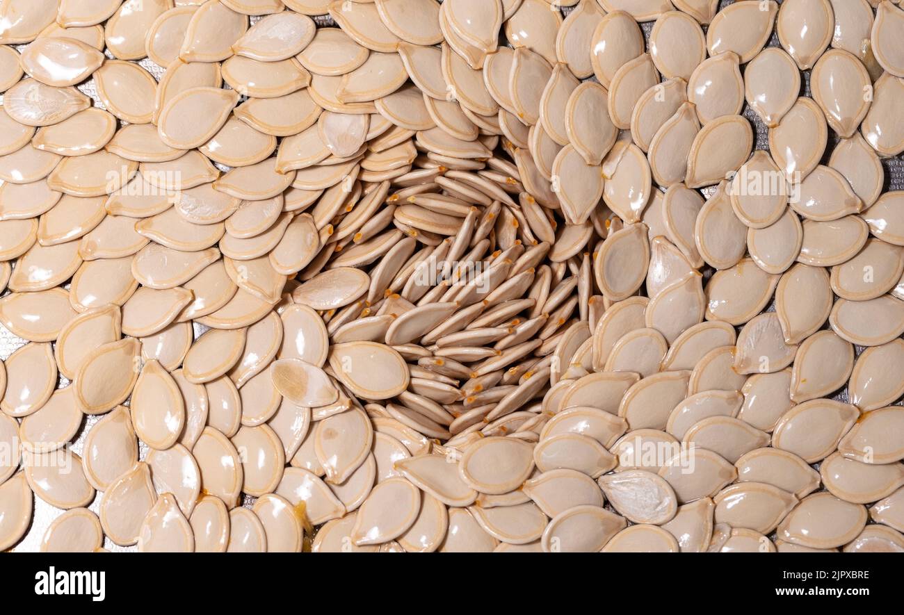Pumpkin seeds creating a natural, spiral structure. Pure pumpkin seeds ...