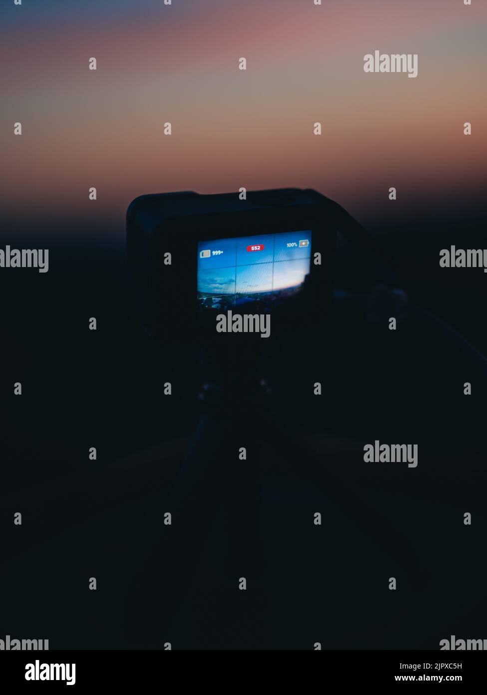 A vertical shot of a camera recording the view during sunset Stock ...