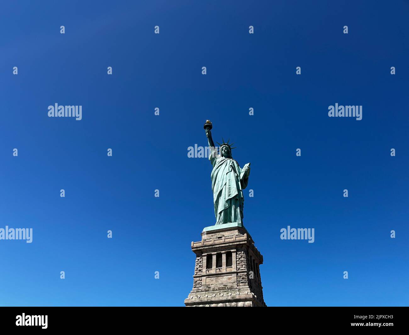 A beautiful view of the Statue of Liberty under the blue sky in New ...