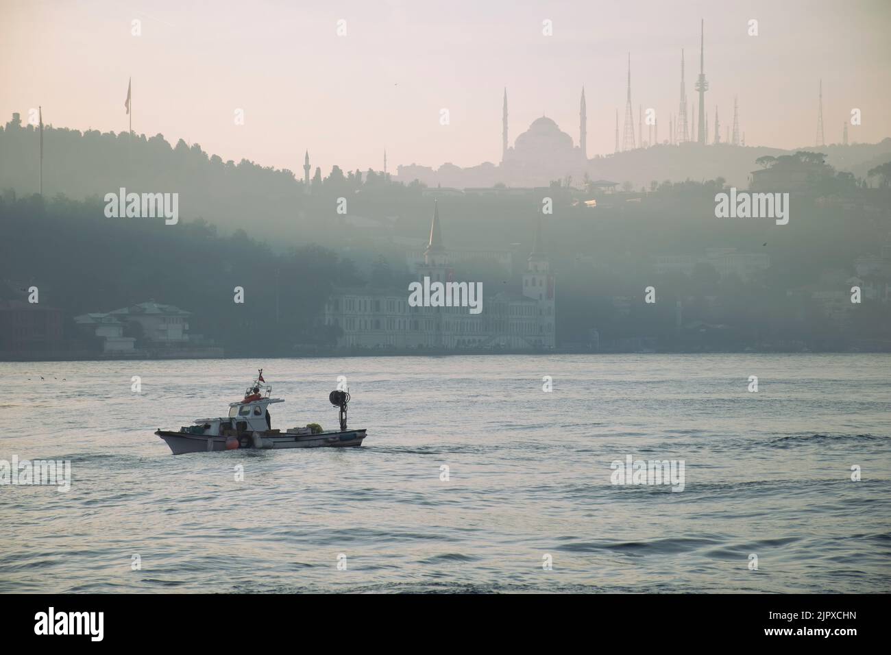 Turkish fisherman sailing in boat in sea. The view of Kuleli Military ...