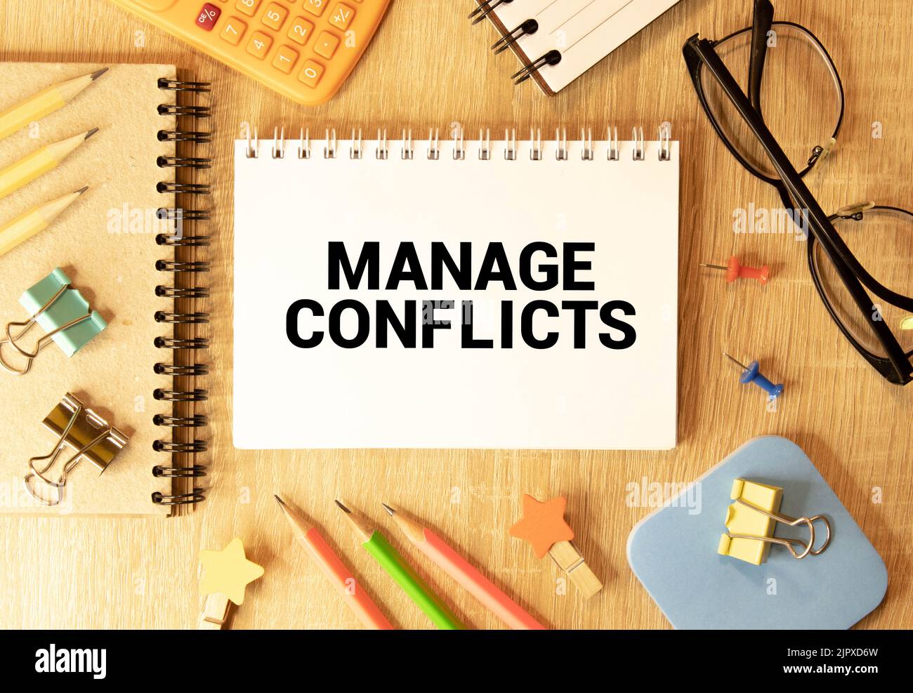 Business concept. Notebook with text MANAGE CONFLICTS sheet of white ...