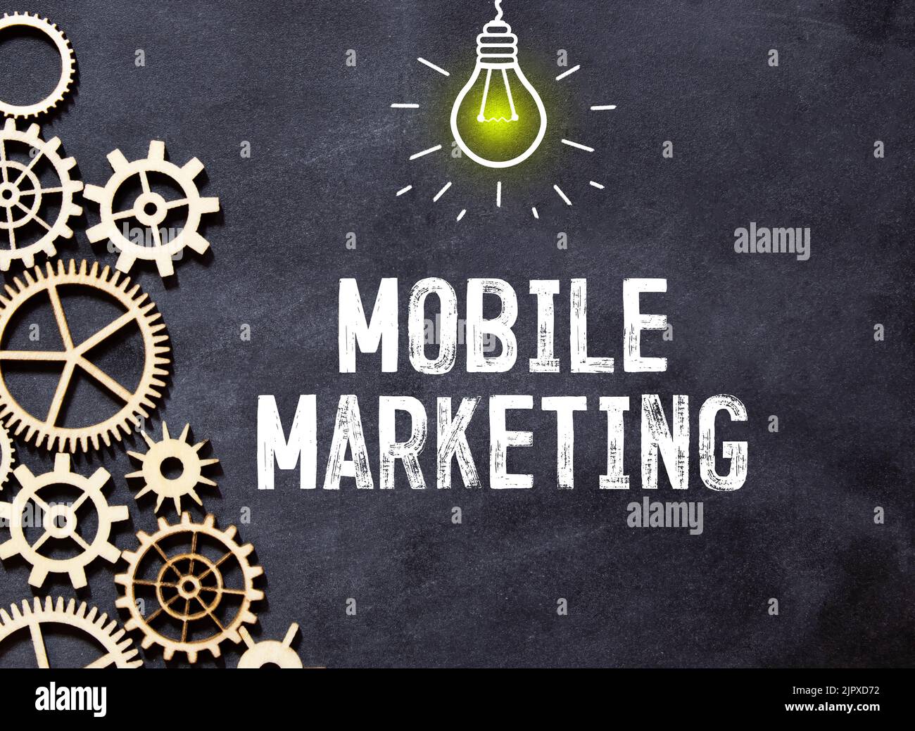 Businessman holds smart phone with mobile marketing words on its screen ...