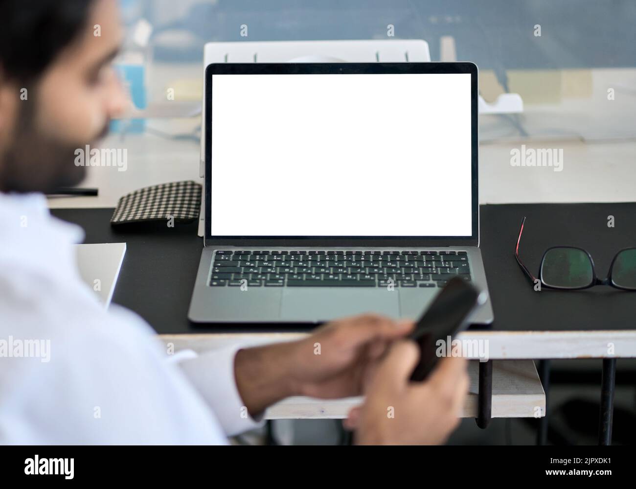 Business man working with mock up laptop white screen on background ...