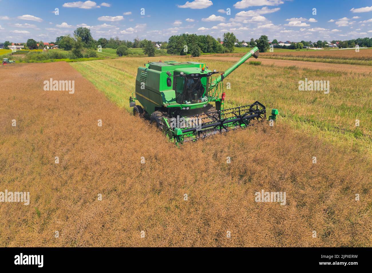 Aerial view of a green agricultural combine with a revolving reel ...