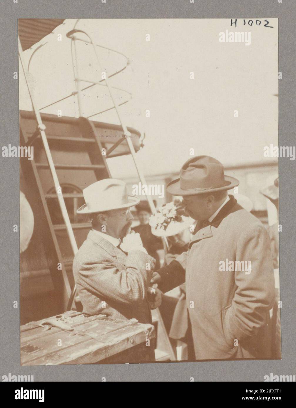 Theodore Roosevelt conversing with a man on deck of ship Stock Photo ...