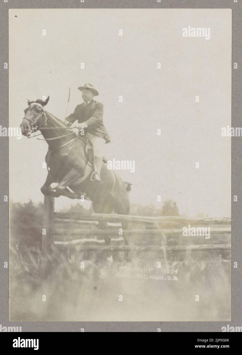 Theodore Roosevelt on horseback jumping over a split rail fence Stock ...