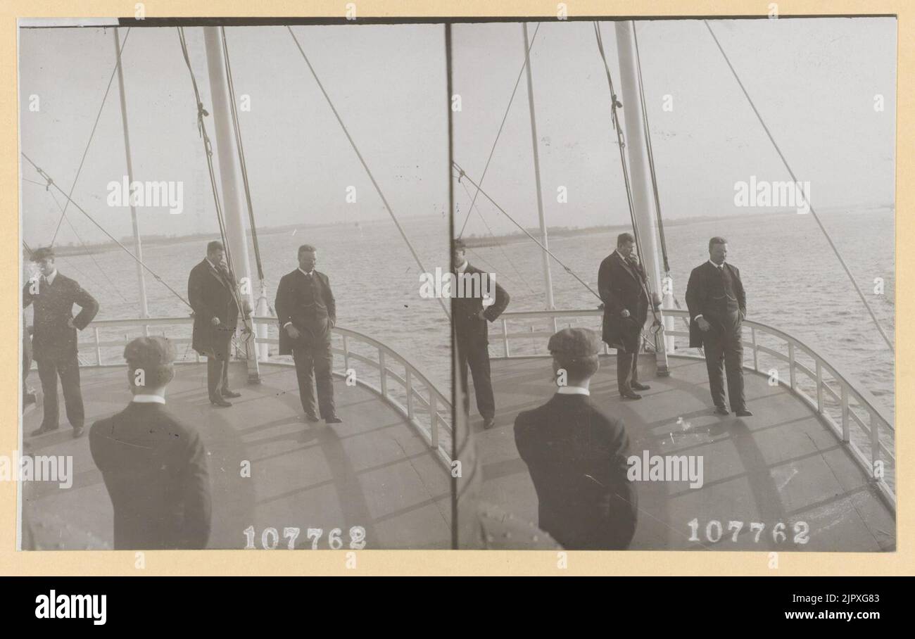 Theodore Roosevelt walking on deck of ship with three men standing ...