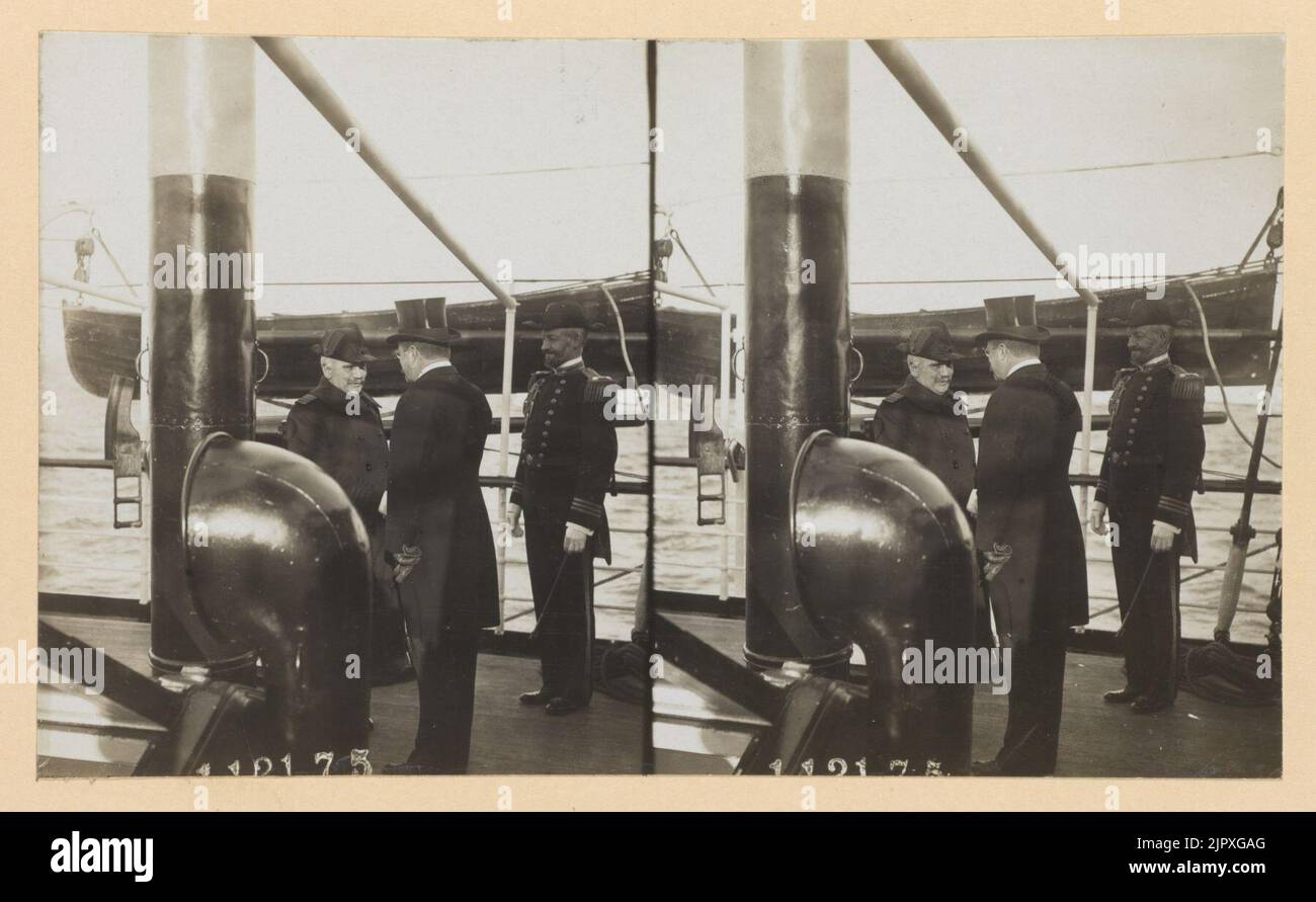 Theodore Roosevelt, back to camera, with two naval officers on deck of ...