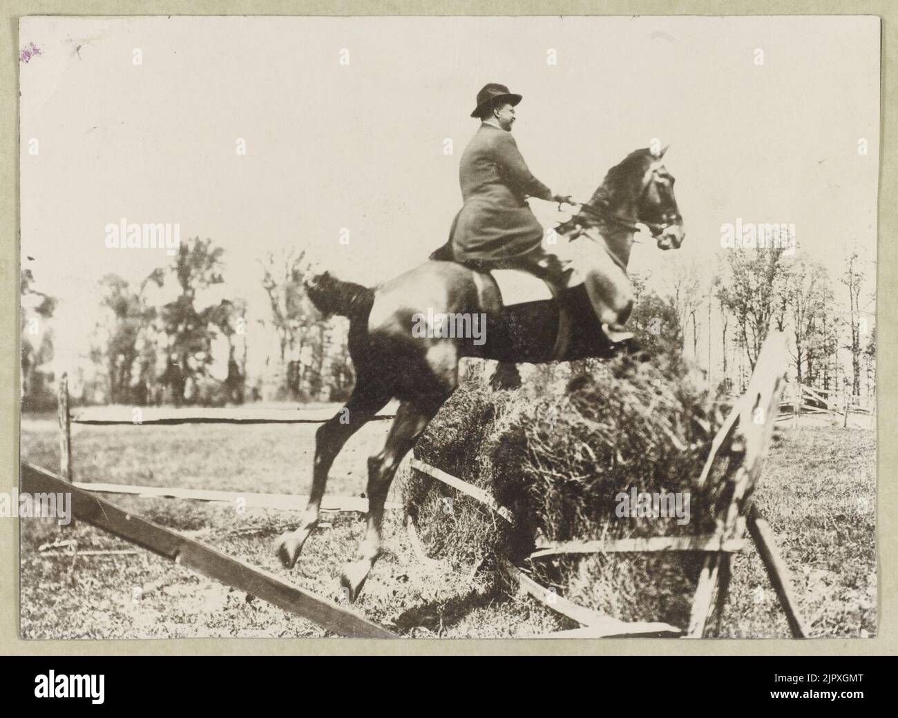 Theodore Roosevelt, side view, on horseback jumping over fence Stock ...