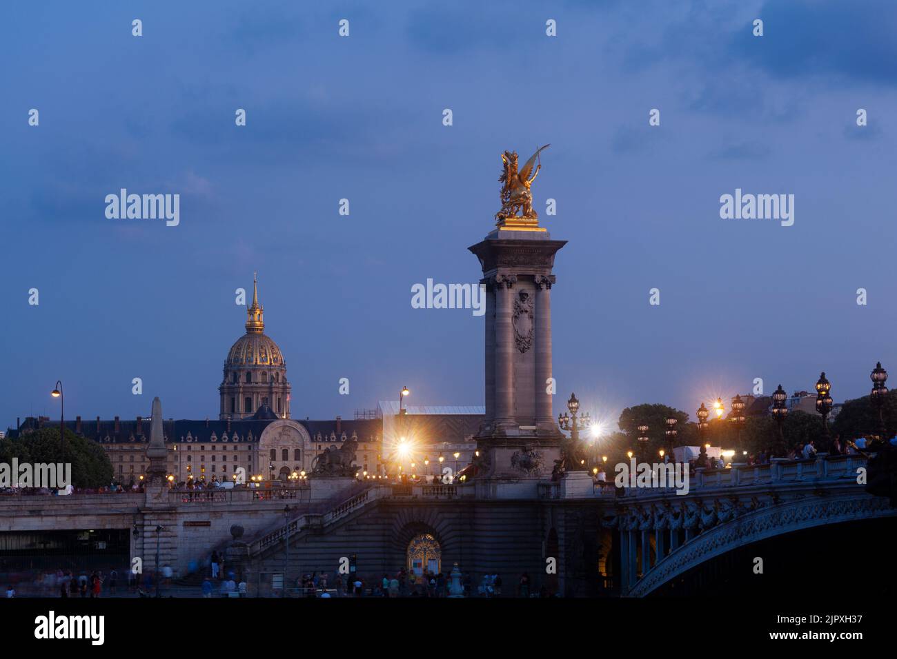Pont Alexandre III Bridge and illuminated lamp posts at sunset with ...