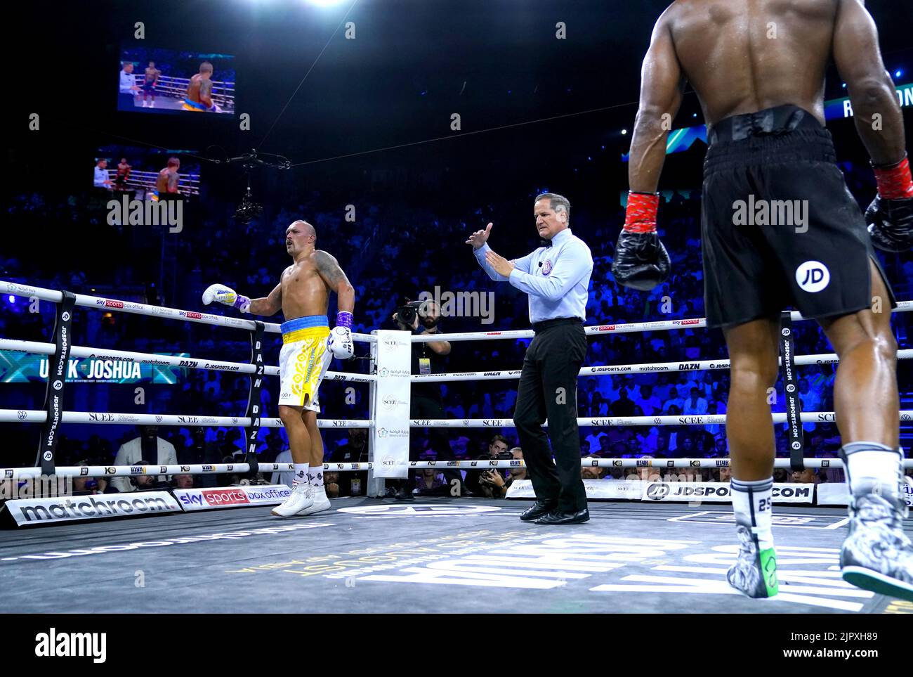 The referee calls a time out for a low blow during the World ...