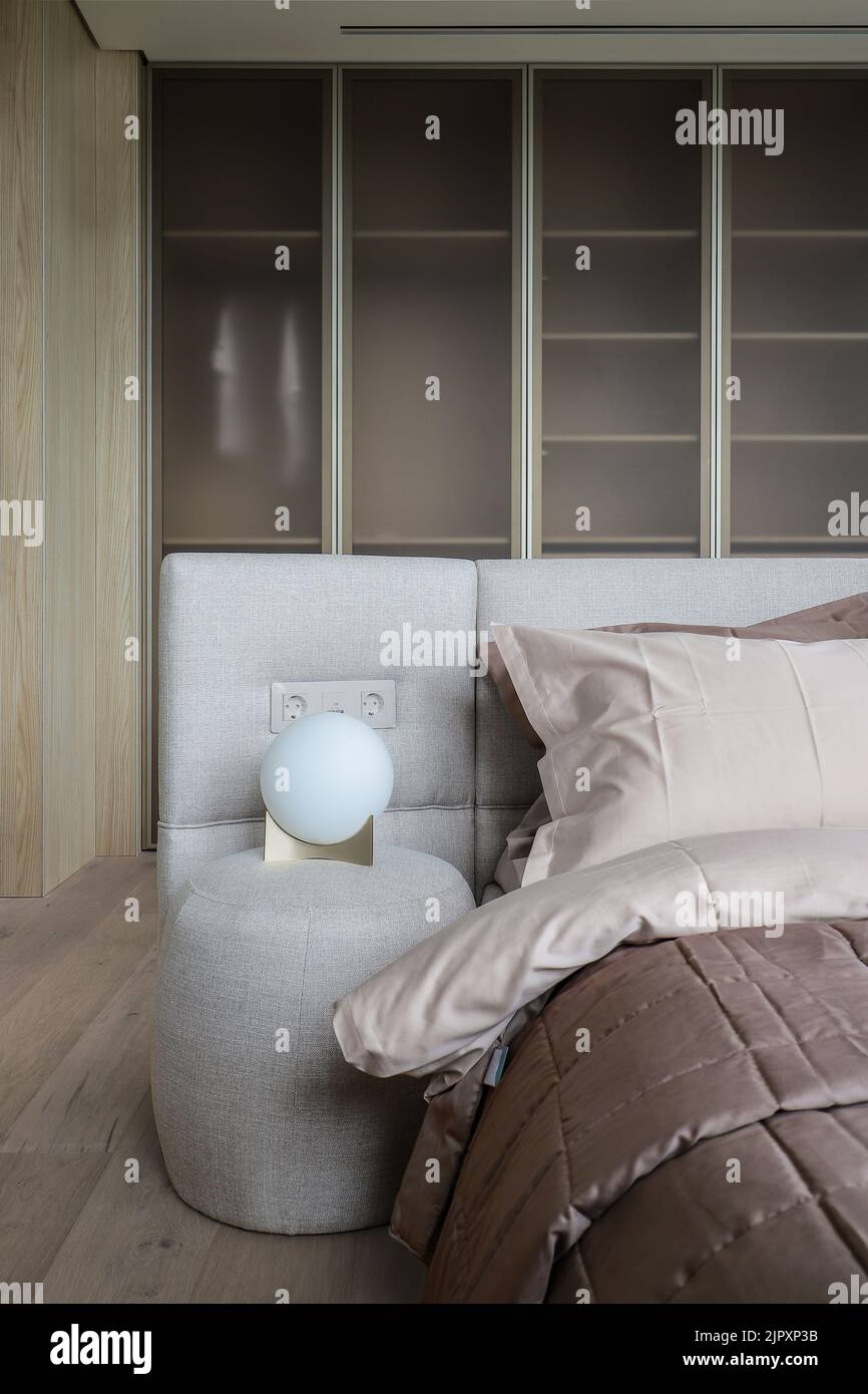 Night light, pillow on the bed in a modern interior design Stock Photo ...