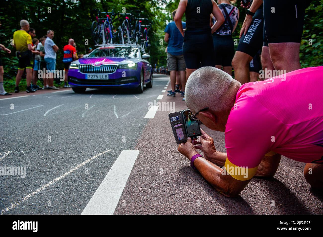 A man is seen taking a photo from below of one of the support cars. The ...