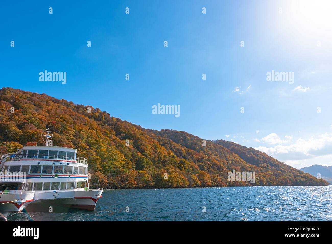 Lake Towada autumn sightseeing Cruises. Beautiful fall foliage view, blue sky sunny day. Towada ...