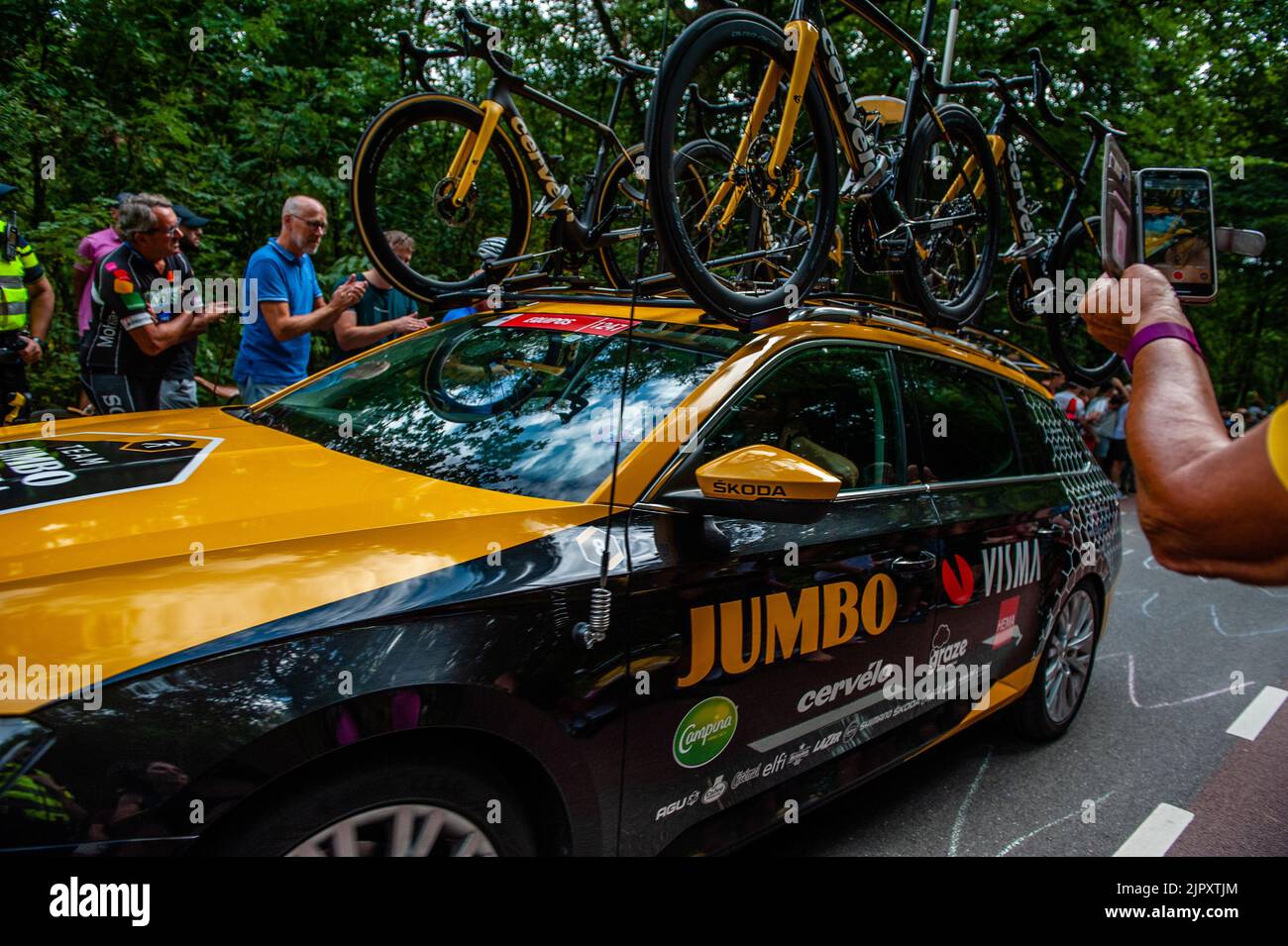 A car from the Dutch team Jumbo is seen passing by in front of the ...