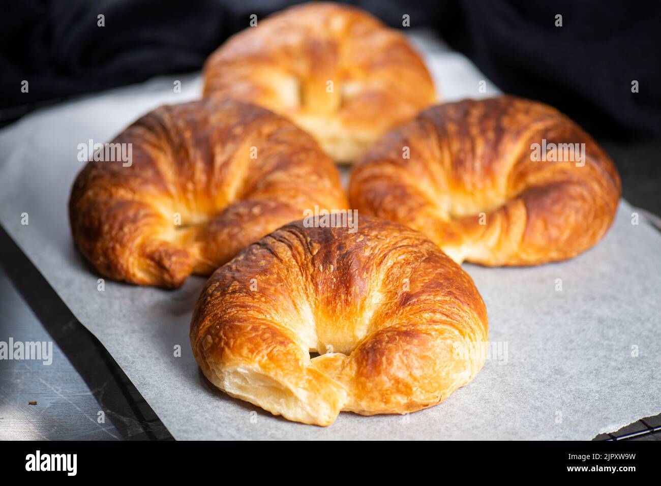 Detailed close-up of delicious buttery traditional croissants with a ...