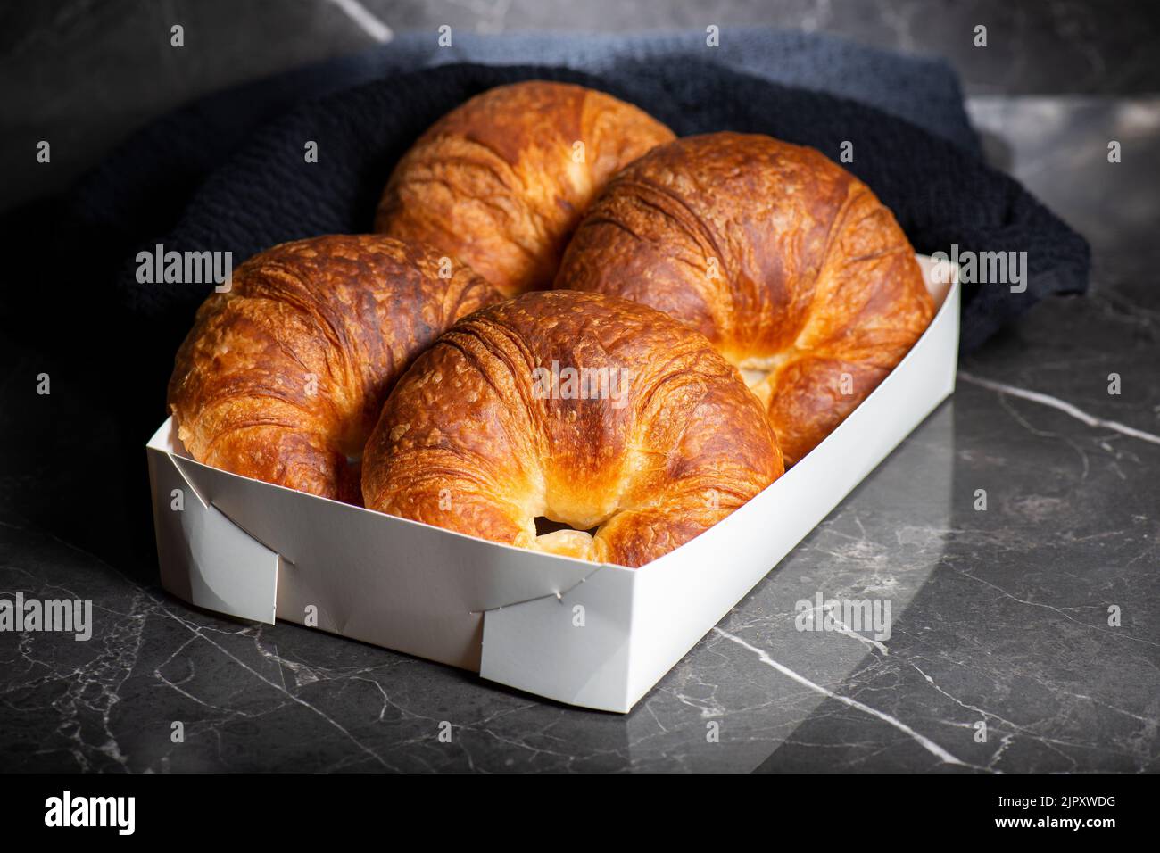 Detailed close-up of delicious buttery traditional croissants with a ...