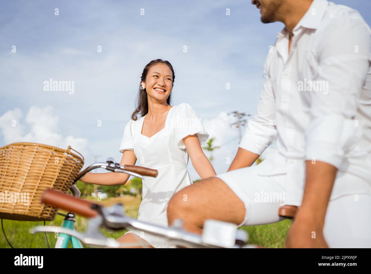 excited young couple enjoy riding their bike together Stock Photo - Alamy